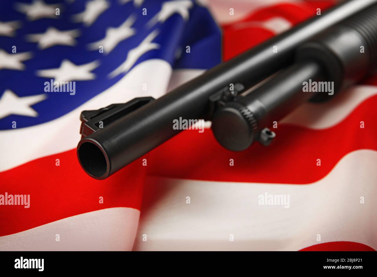 Gun on USA flag background Stock Photo - Alamy