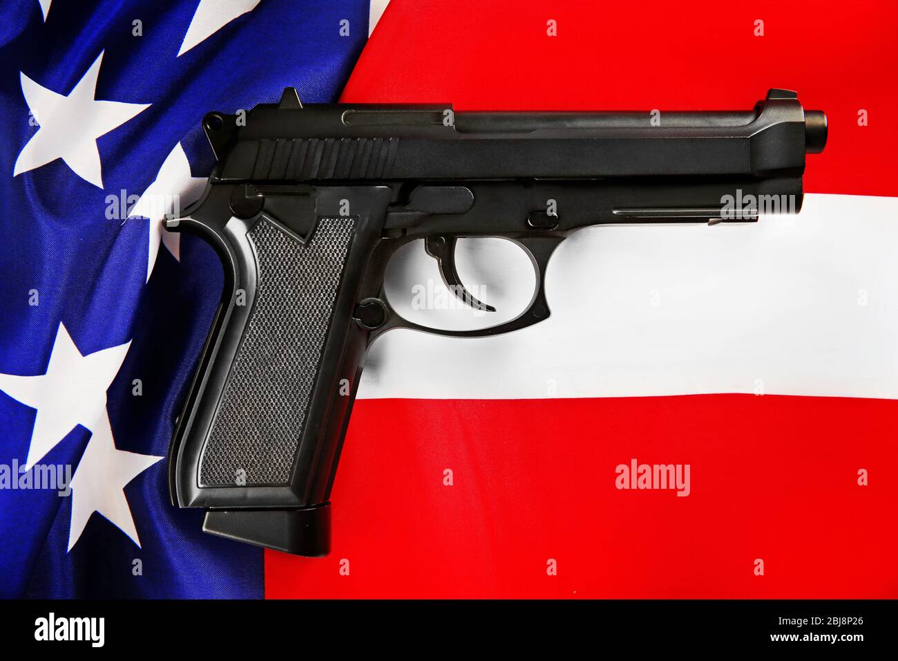 Gun on USA flag background Stock Photo - Alamy