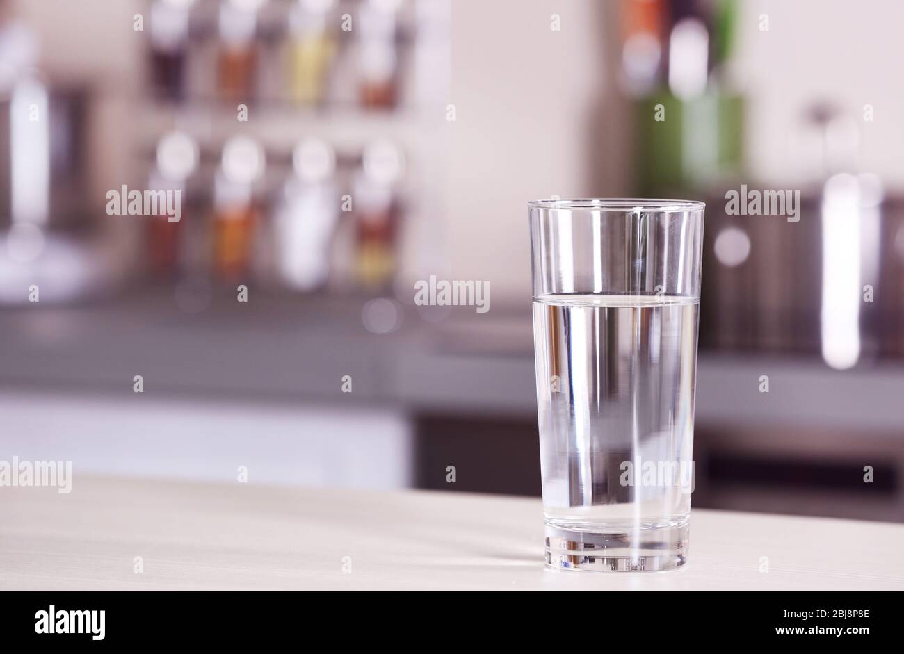 Glass of pure water on kitchen table Stock Photo - Alamy