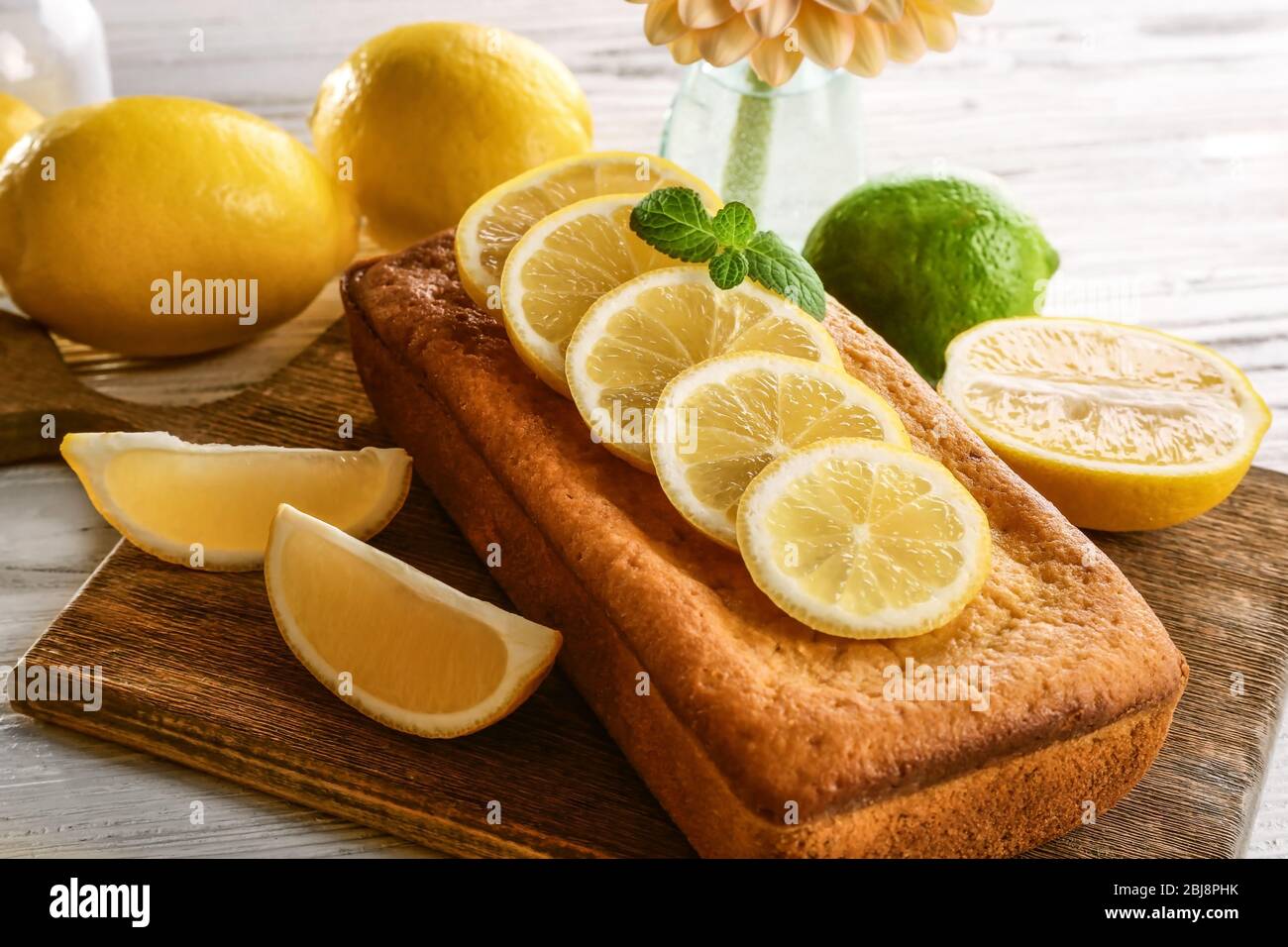 Delicious citrus cake loaf with lemons on wooden board Stock Photo - Alamy