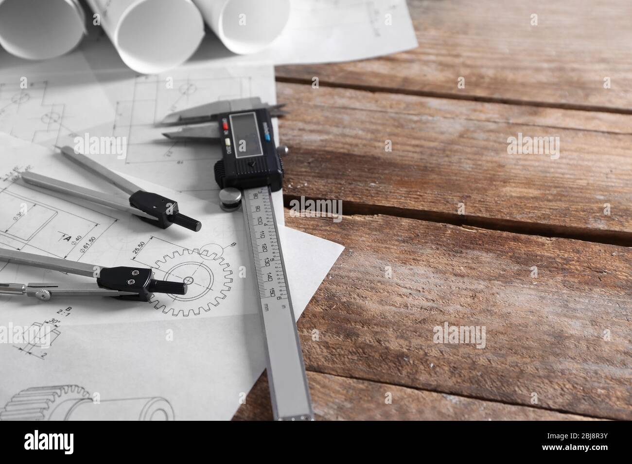 Set of engineering drawings with tools on wooden background Stock Photo ...