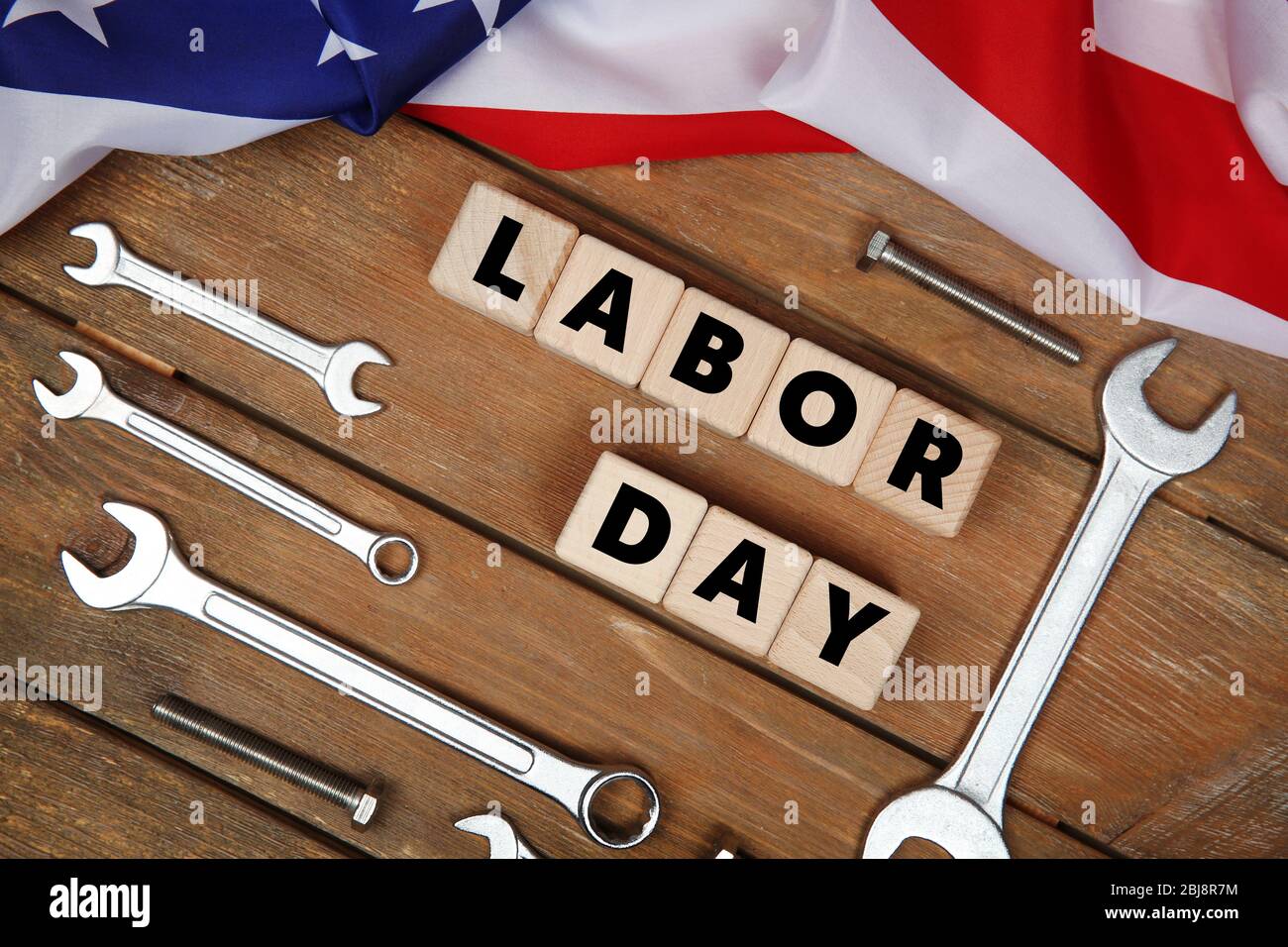Labor day concept. Different kinds on wrenches and wooden cubes on ...