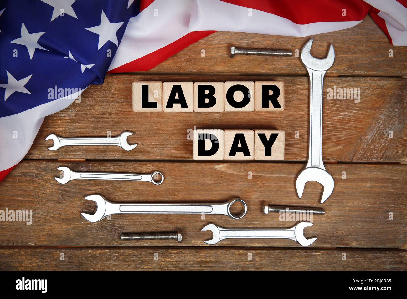 Labor day concept. Different kinds on wrenches and wooden cubes on ...