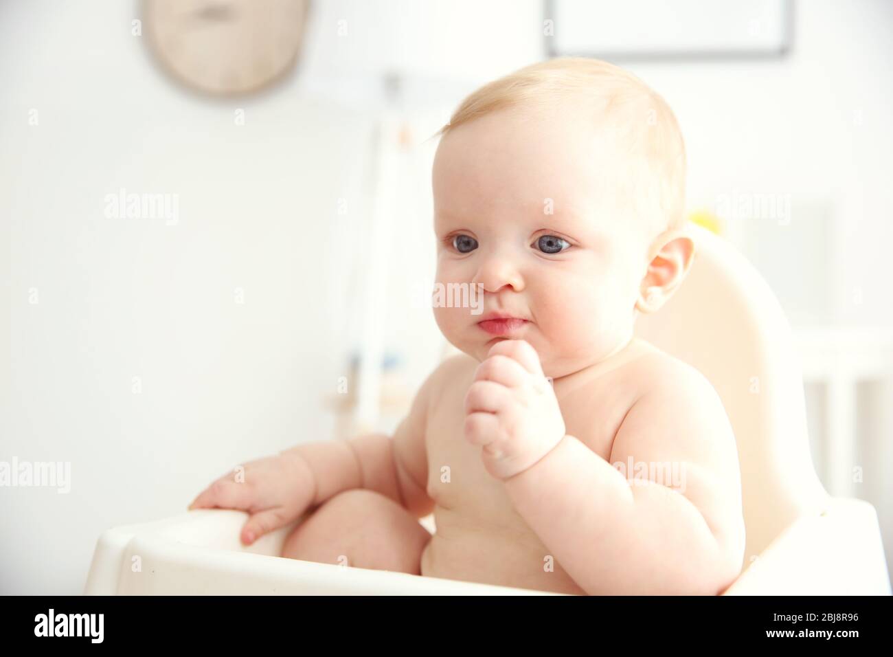 Baby boy sitting in chair Stock Photo - Alamy
