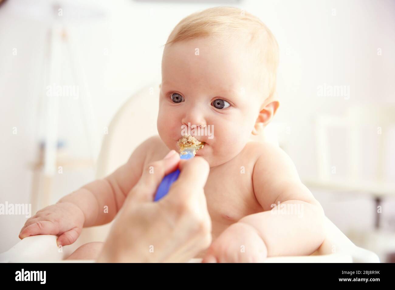 Baby boy sitting in chair Stock Photo - Alamy