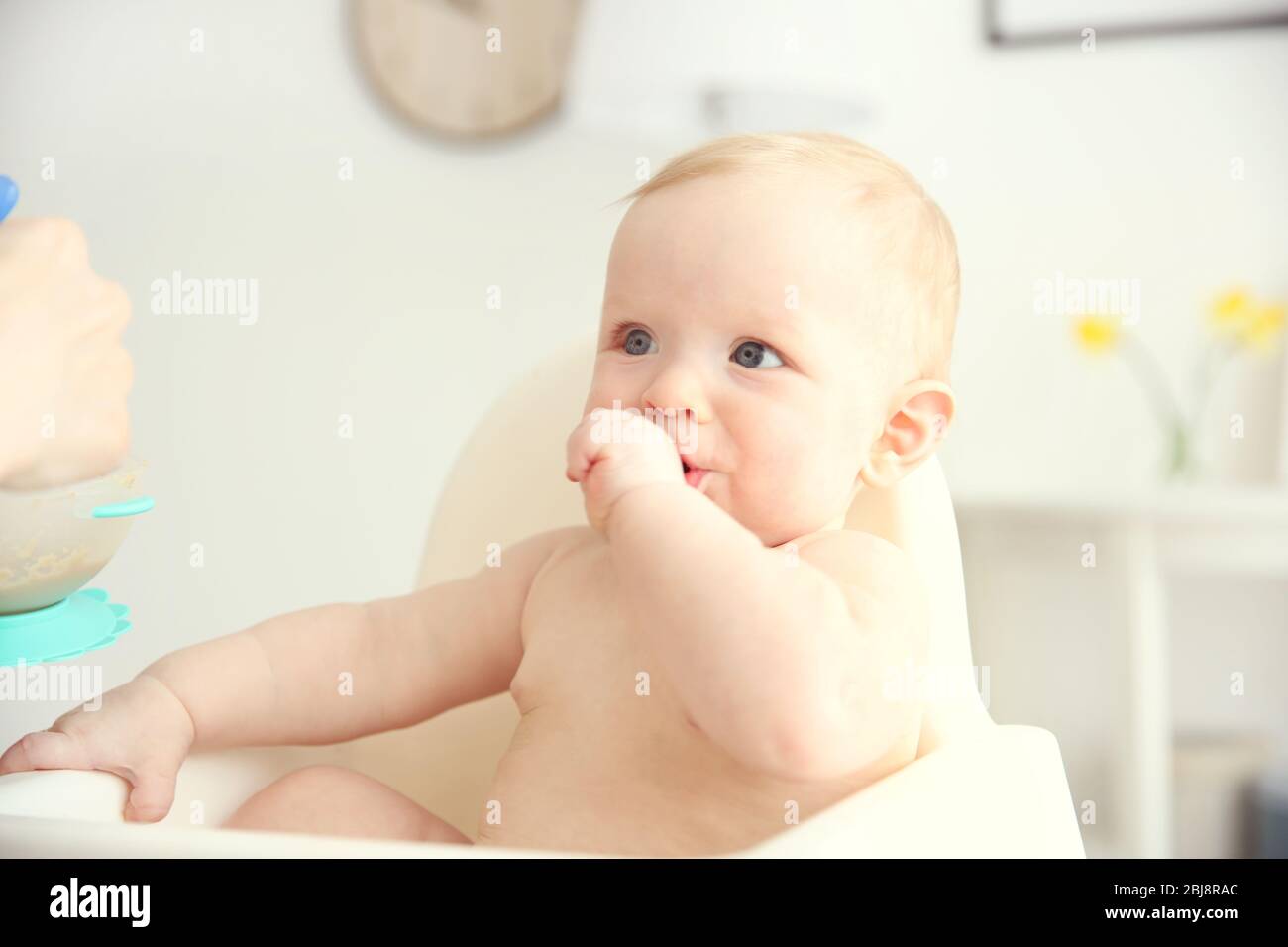 Baby boy sitting in chair Stock Photo - Alamy