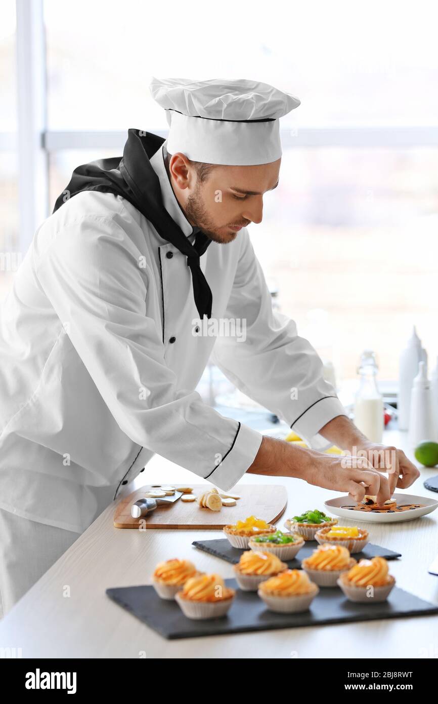 Male chef working at kitchen Stock Photo - Alamy