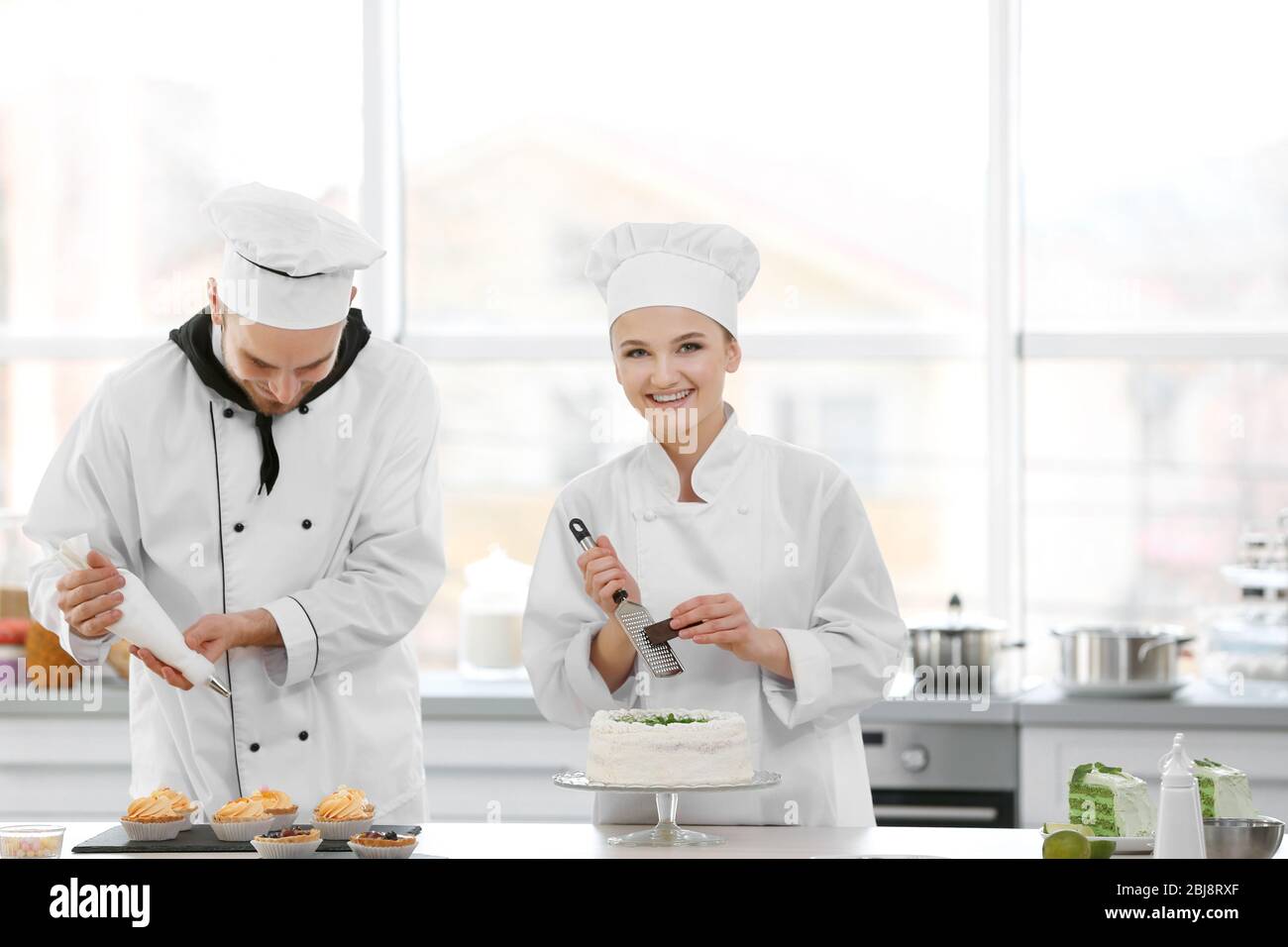 Male and female chefs working at kitchen Stock Photo - Alamy