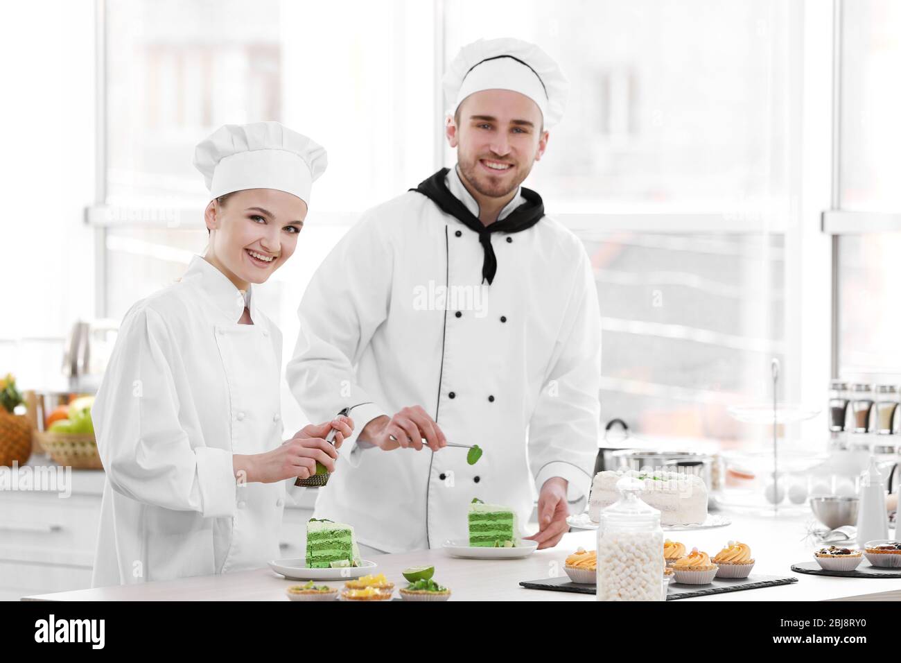 Male and female chefs working at kitchen Stock Photo - Alamy