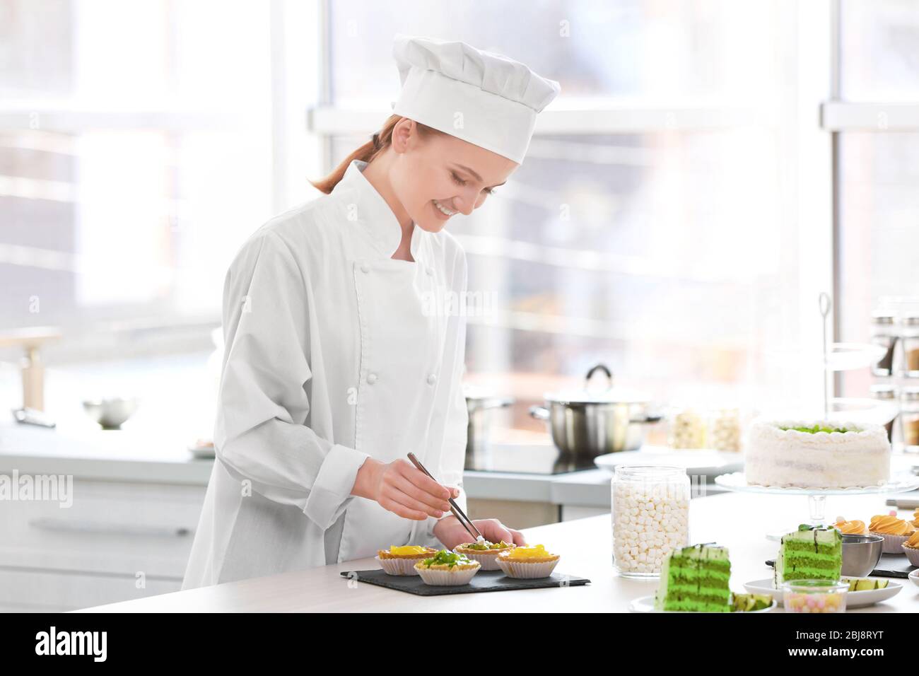 Female chef working at kitchen Stock Photo - Alamy