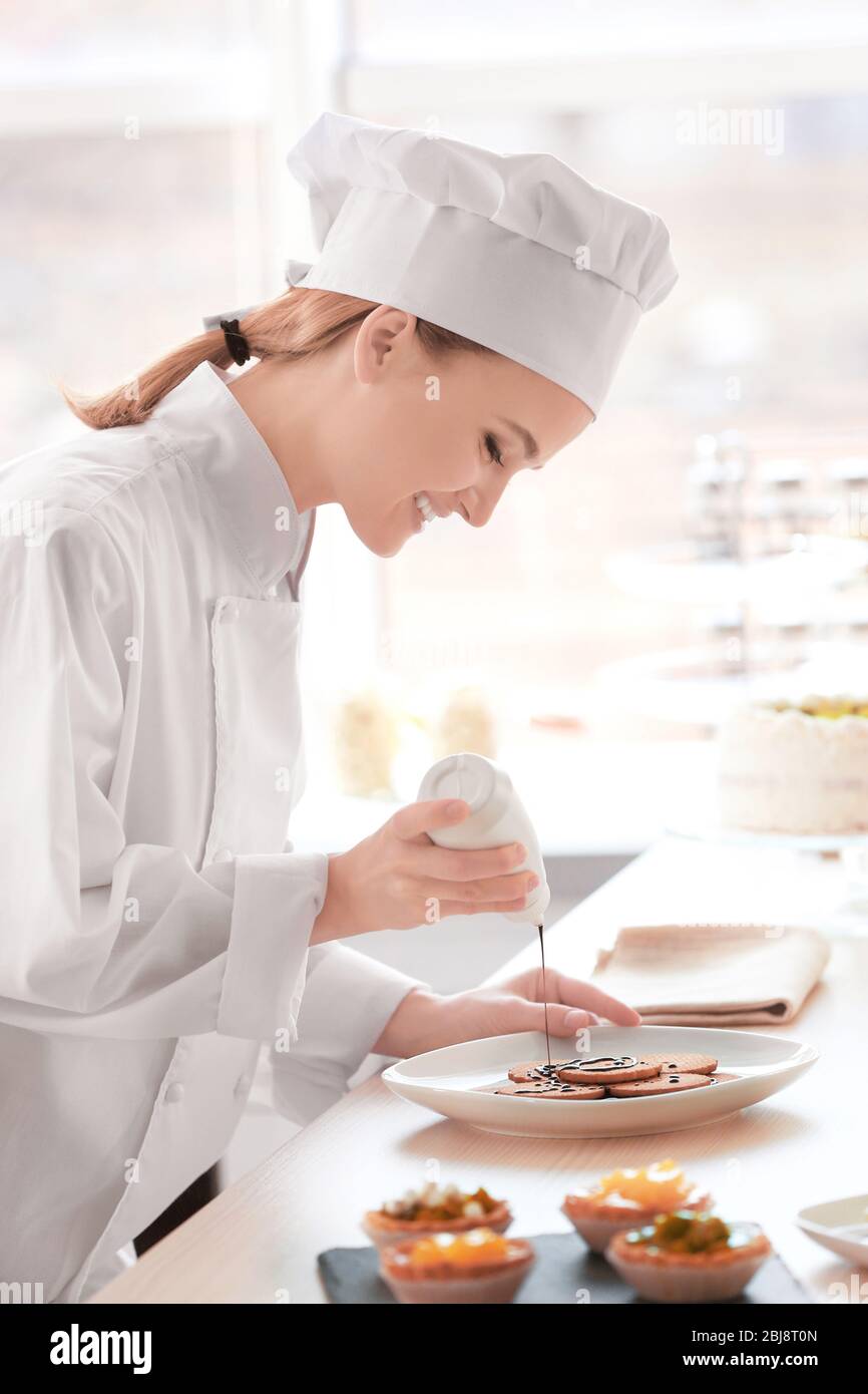 Female chef working at kitchen Stock Photo - Alamy