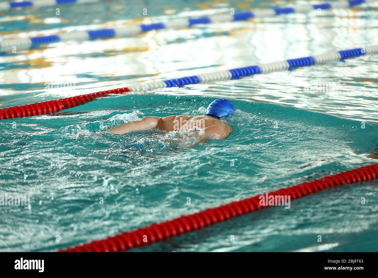 Sporty young man swimming in the pool Stock Photo - Alamy