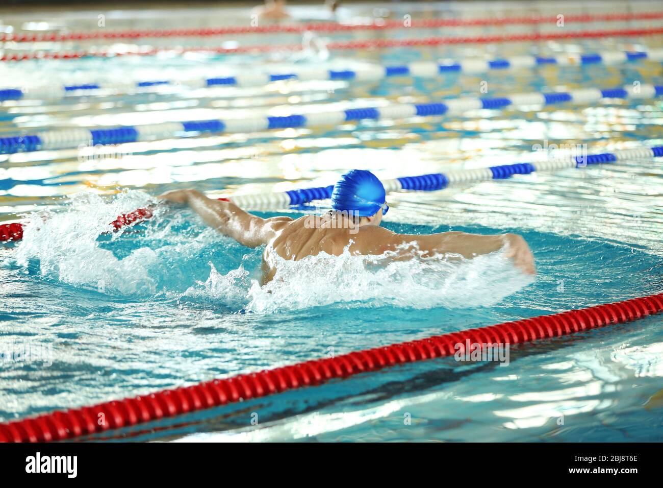 Sporty young man swimming in the pool Stock Photo - Alamy