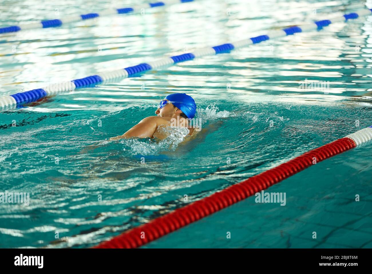 Sporty young man swimming in the pool Stock Photo - Alamy