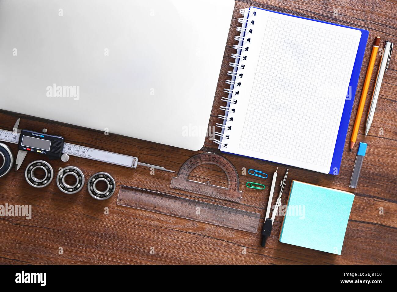 Laptop, notebook and engineering tools on wooden table, top view Stock ...