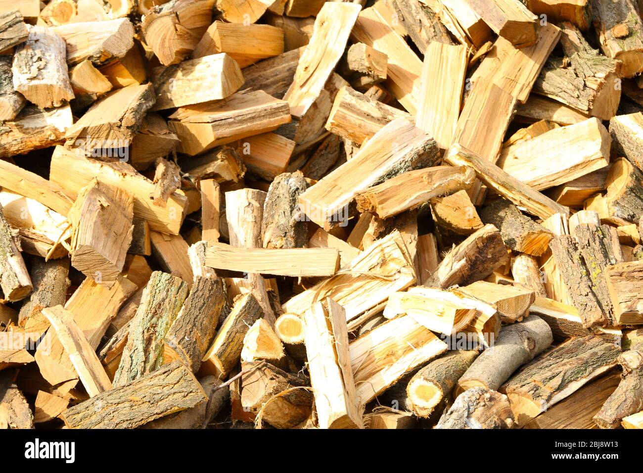 Firewood background - chopped firewood Stock Photo - Alamy