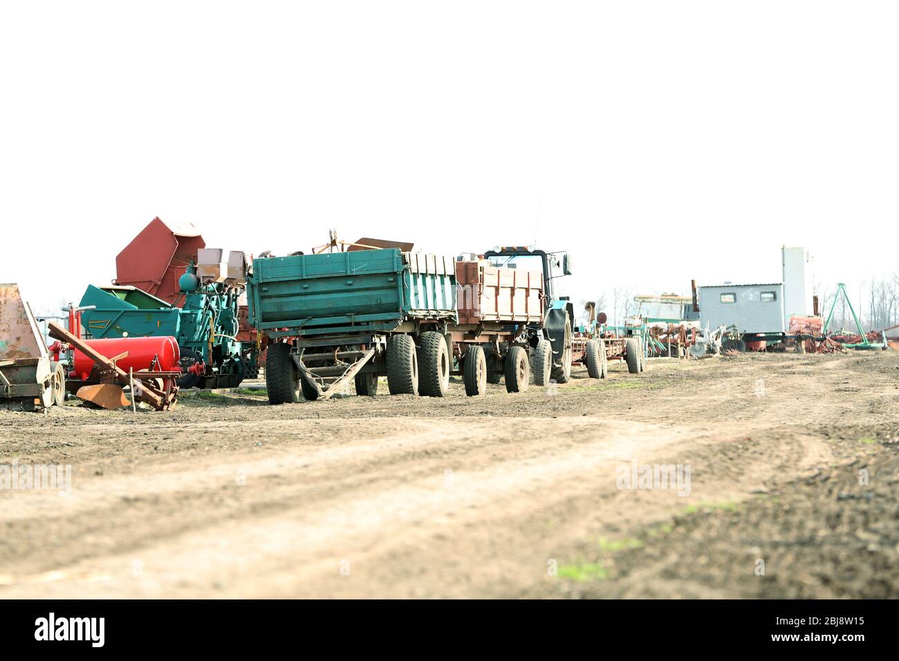 Tractors and truck with platforms on a farm Stock Photo - Alamy