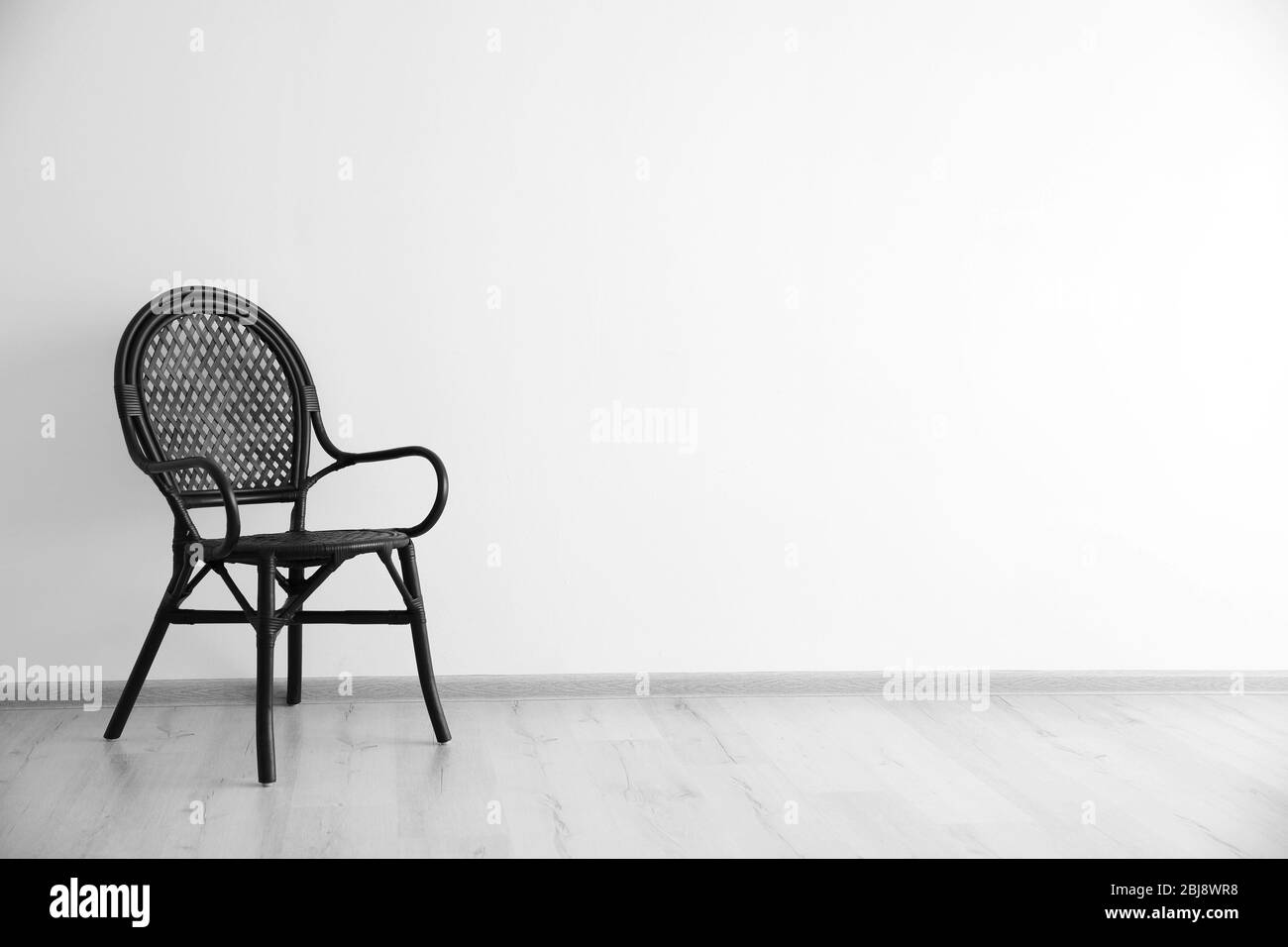Cozy chair on wall background Stock Photo - Alamy