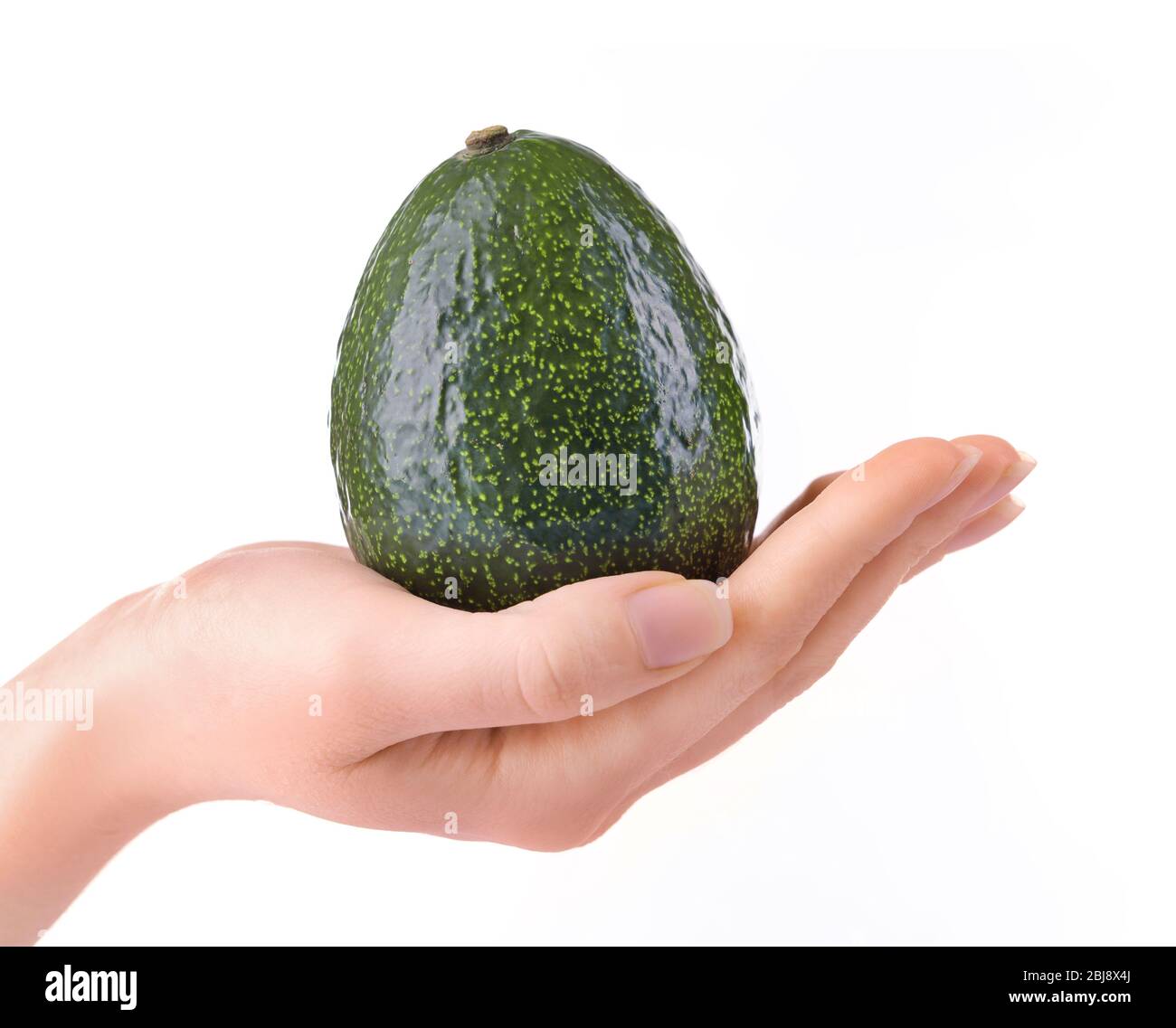 Female hand holding avocado, isolated on white Stock Photo - Alamy