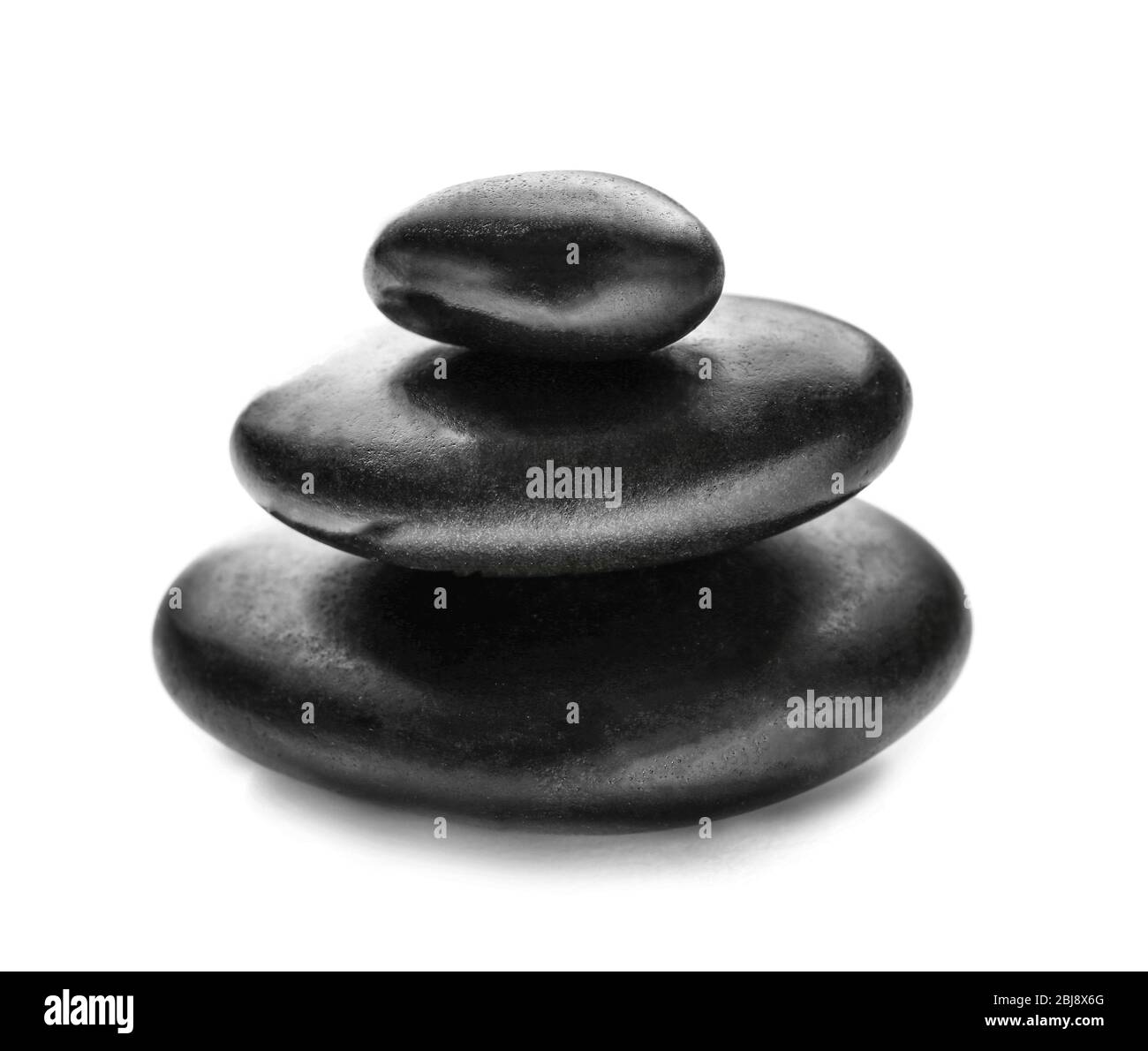 Stack of spa hot stones isolated on white Stock Photo - Alamy