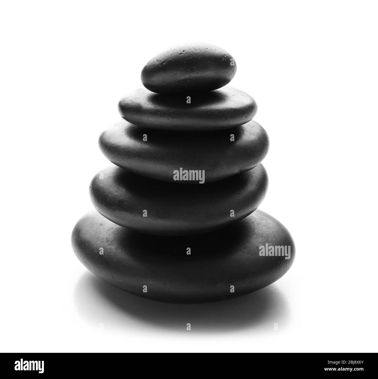 Stack of spa hot stones isolated on white Stock Photo - Alamy