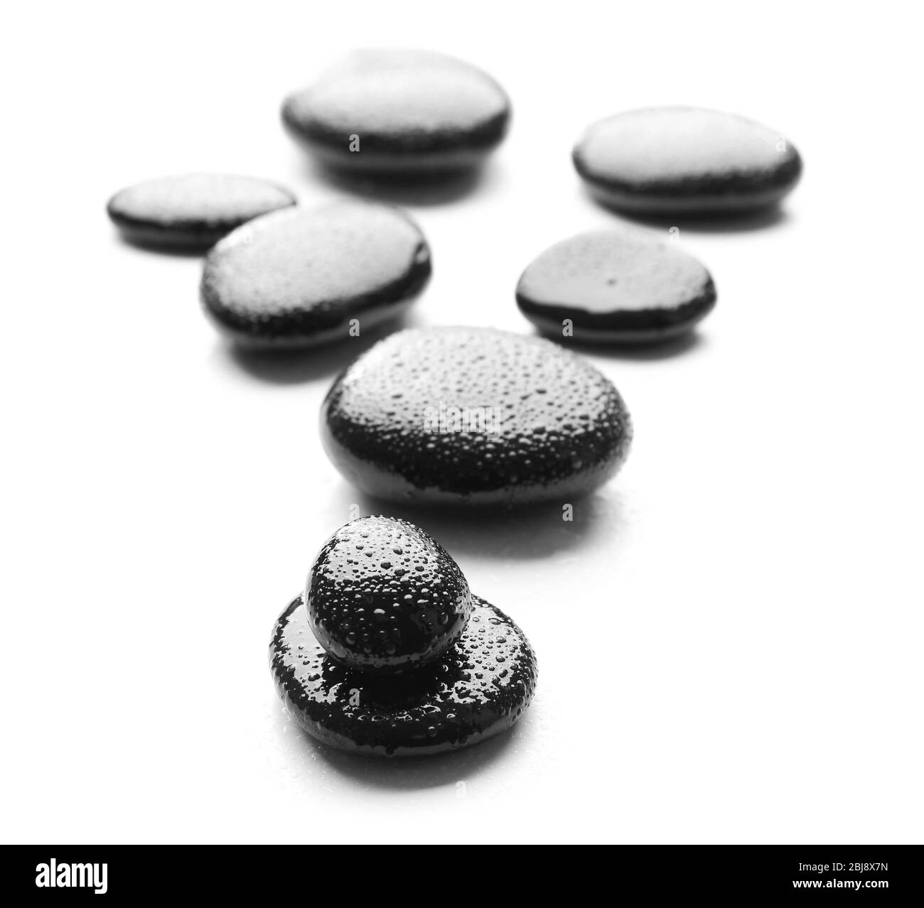 Heap of spa hot stones isolated on white Stock Photo - Alamy
