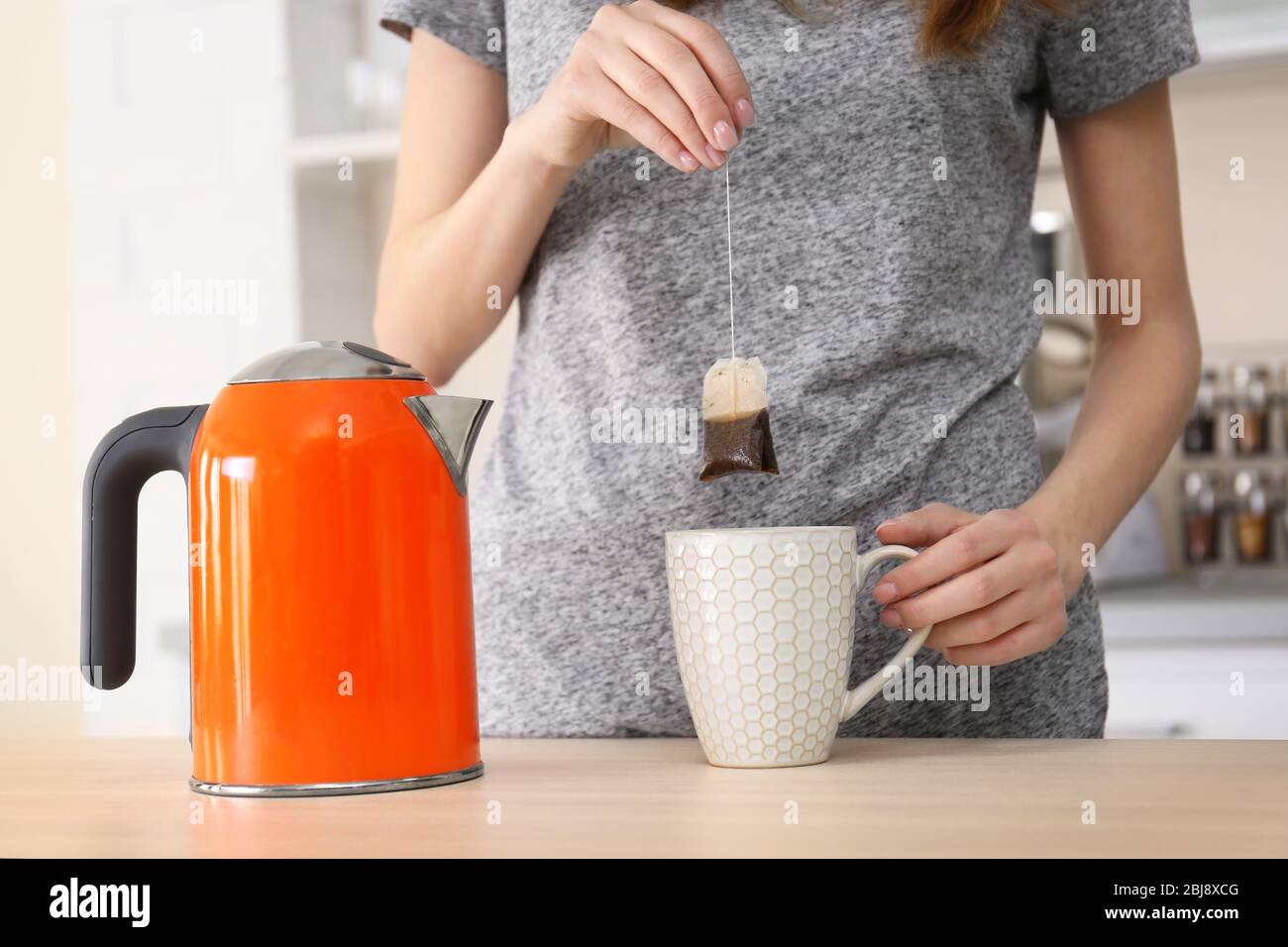 Woman making tea in the kitchen Stock Photo - Alamy