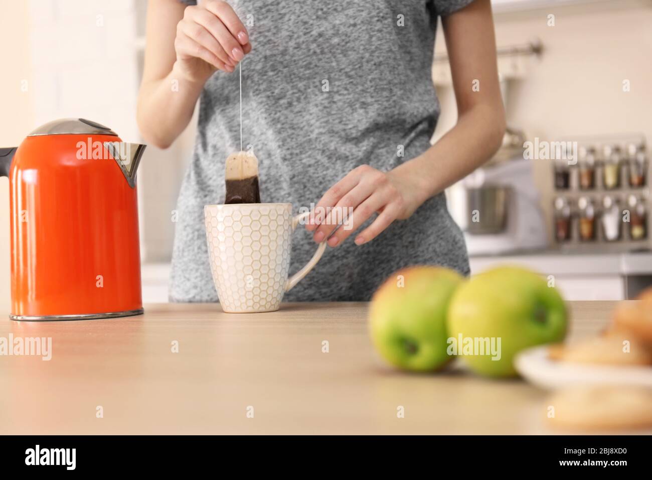 Woman making tea in the kitchen Stock Photo - Alamy