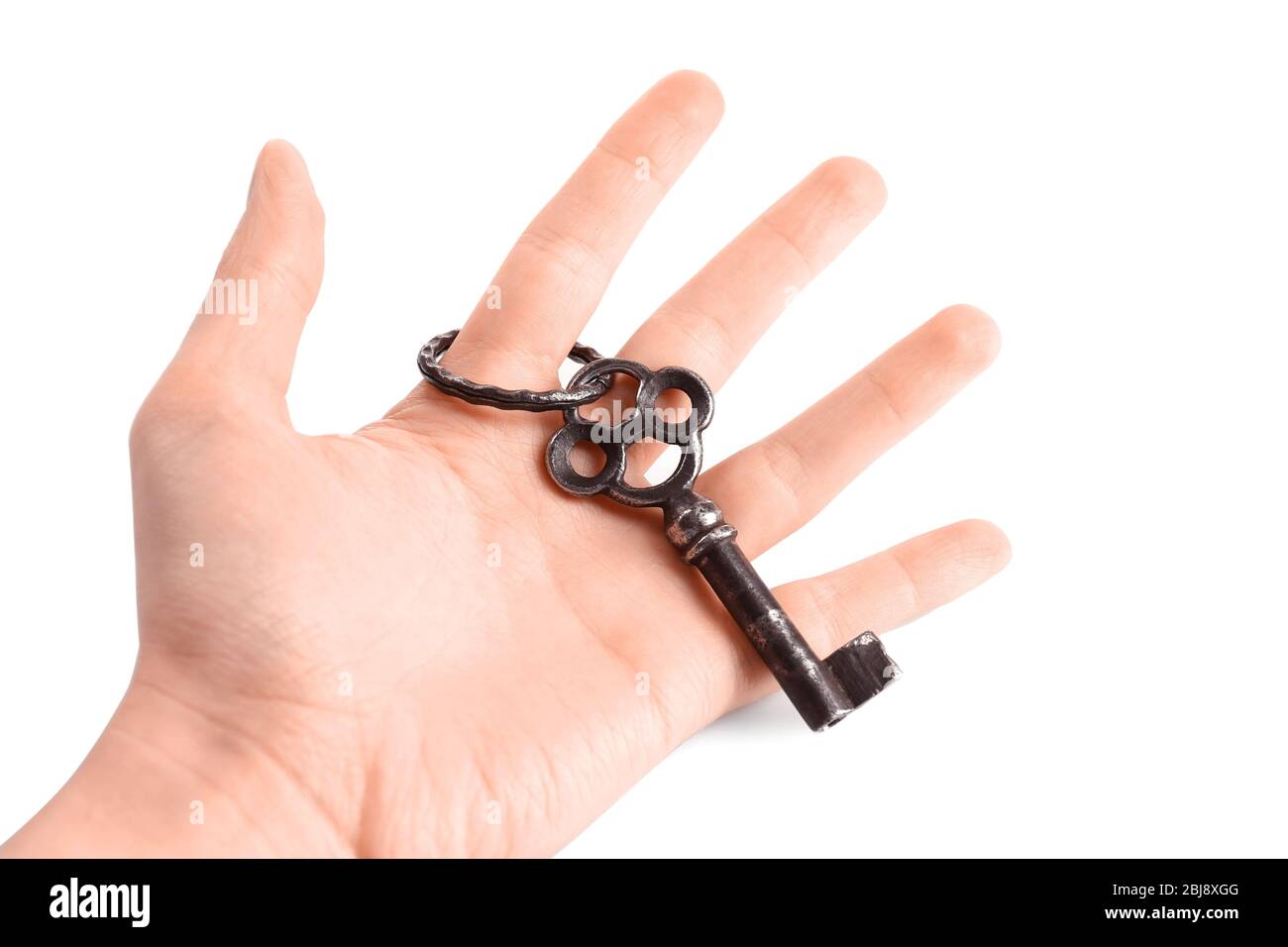 Hand holding an old key isolated on white Stock Photo - Alamy