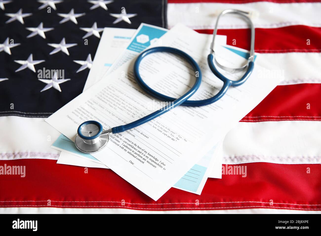 Stethoscope and medical forms on USA flag background. American medicine ...