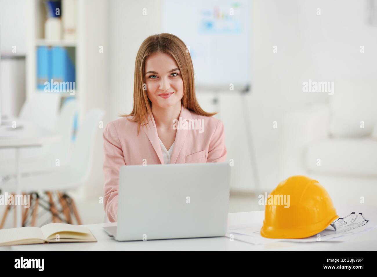 Young female engineer working in the office Stock Photo - Alamy