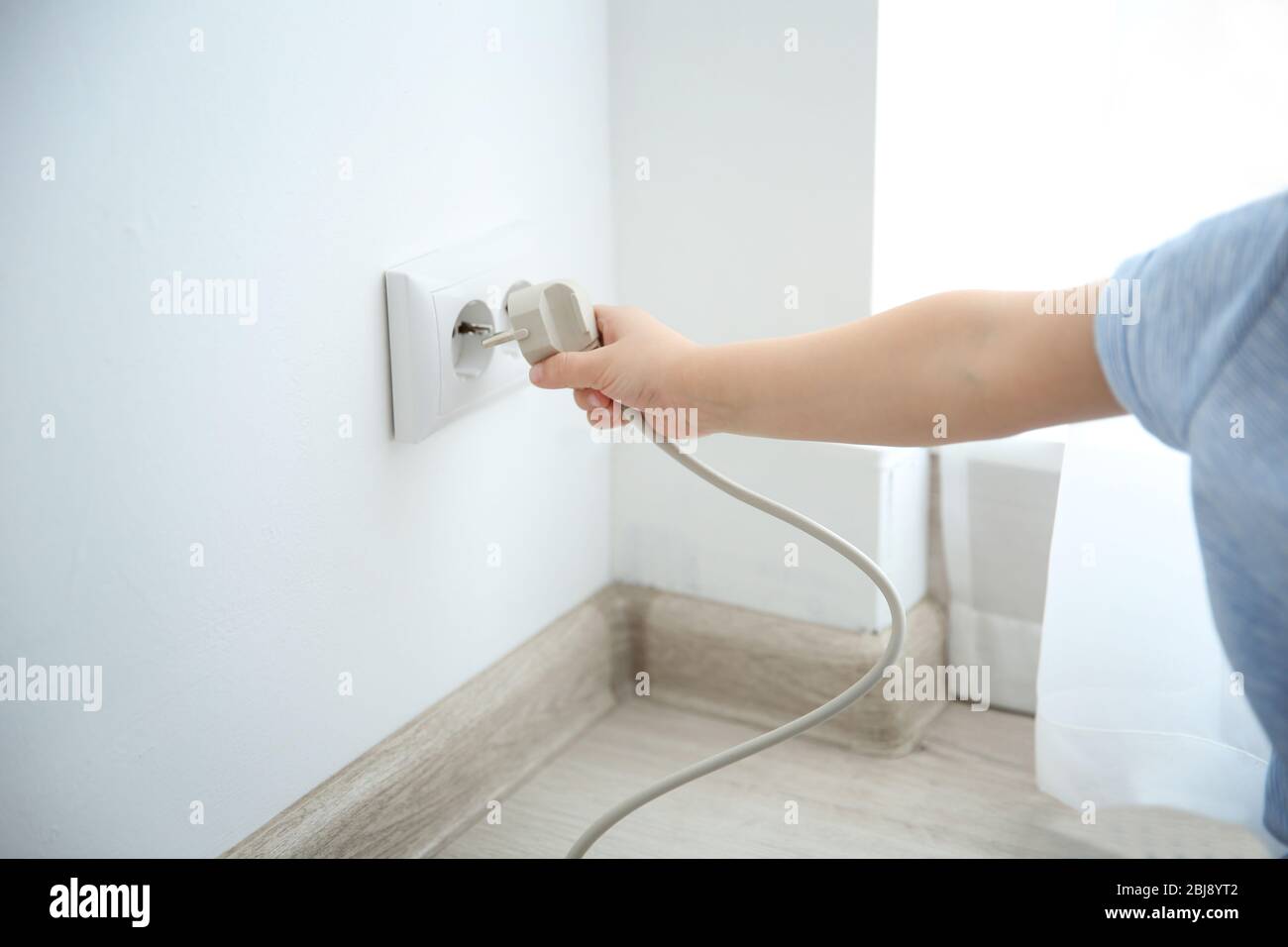 Little boy playing with wire and plug Stock Photo - Alamy