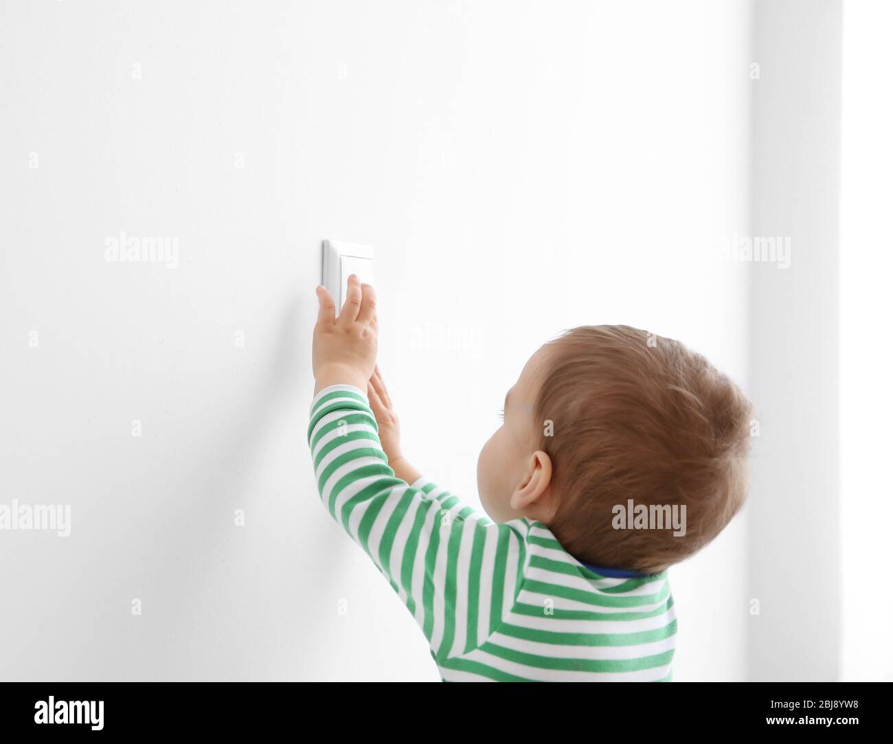 Little child playing with switch Stock Photo - Alamy