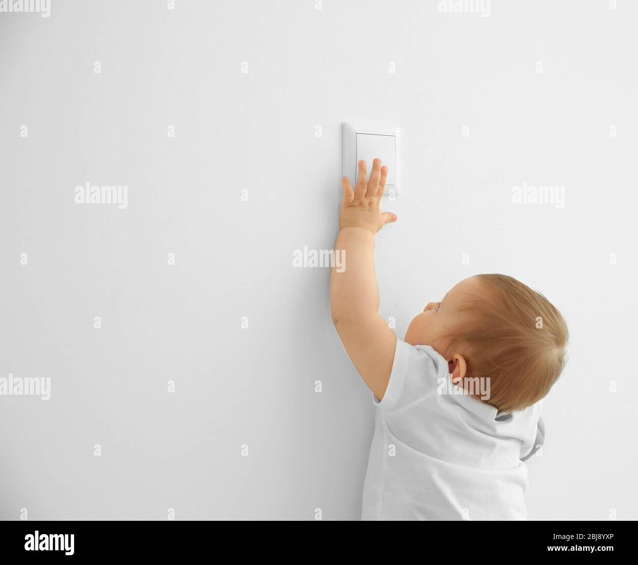 Little child playing with switch Stock Photo - Alamy