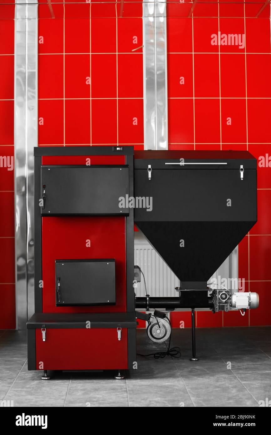 Solid-fuel boiler in the boiler room Stock Photo - Alamy