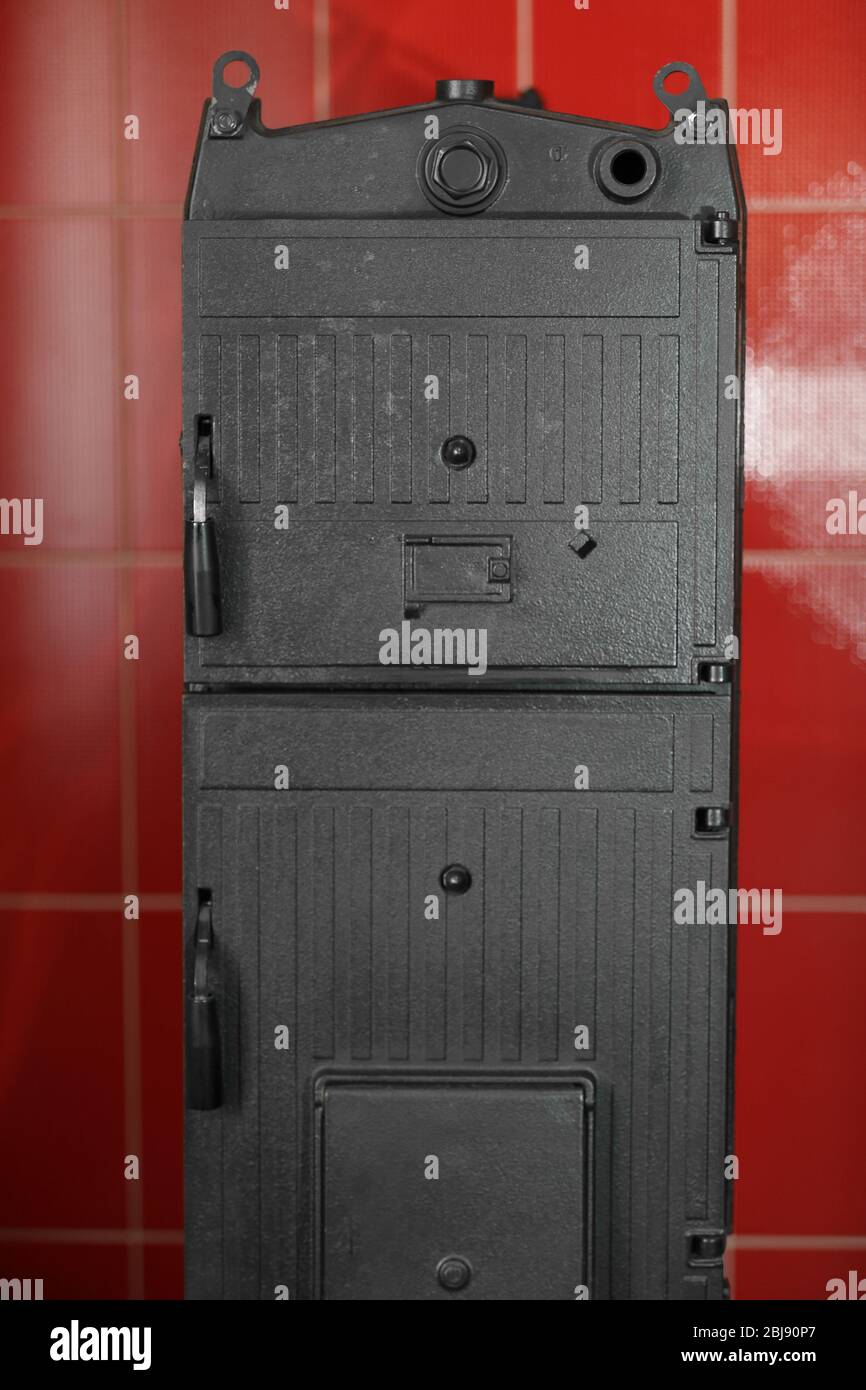 Solid-fuel boiler in the boiler room Stock Photo - Alamy