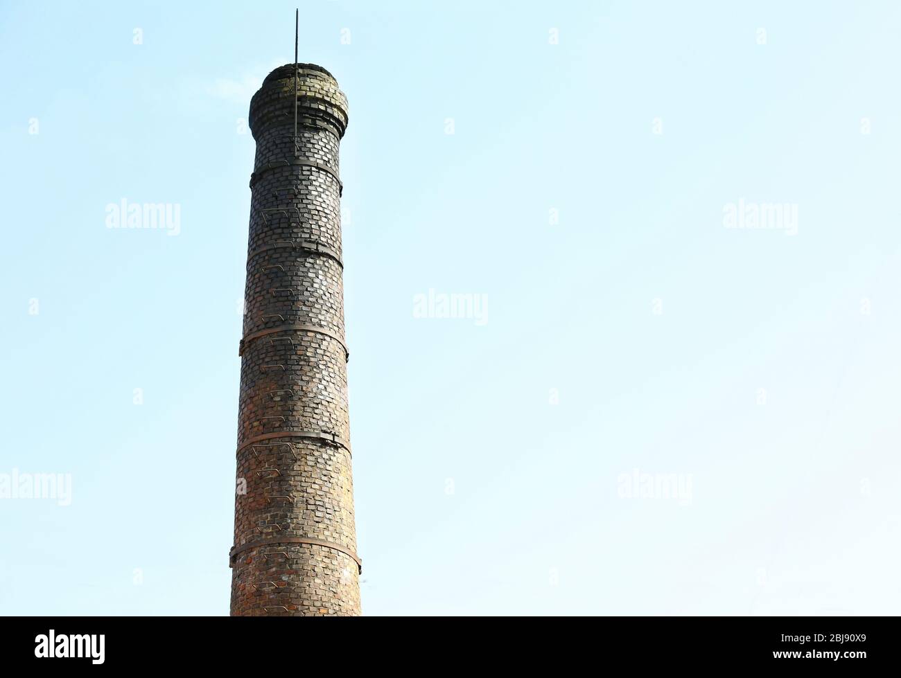 Brick industrial flue on sky background Stock Photo - Alamy