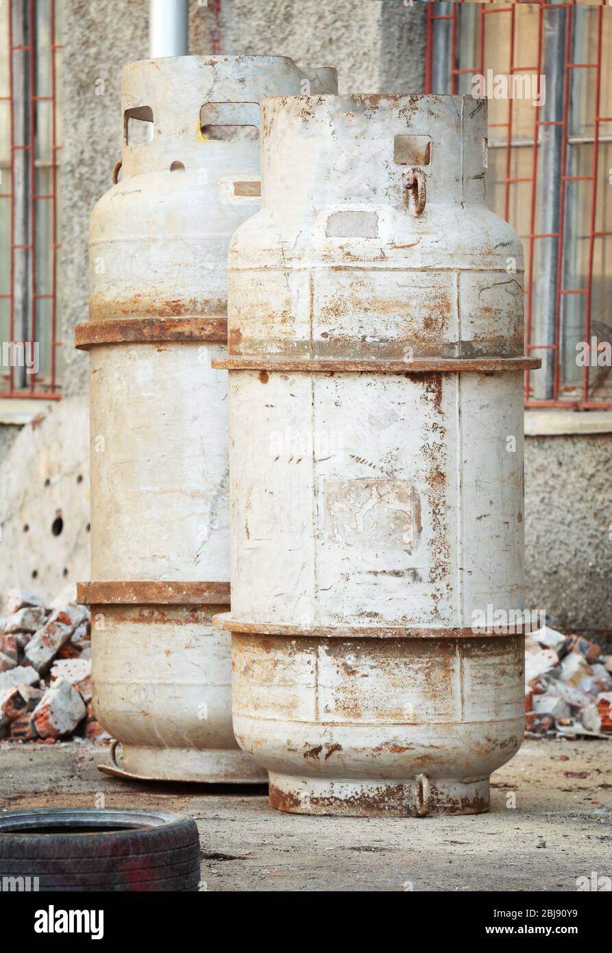 Old metal containers on window background outside Stock Photo - Alamy