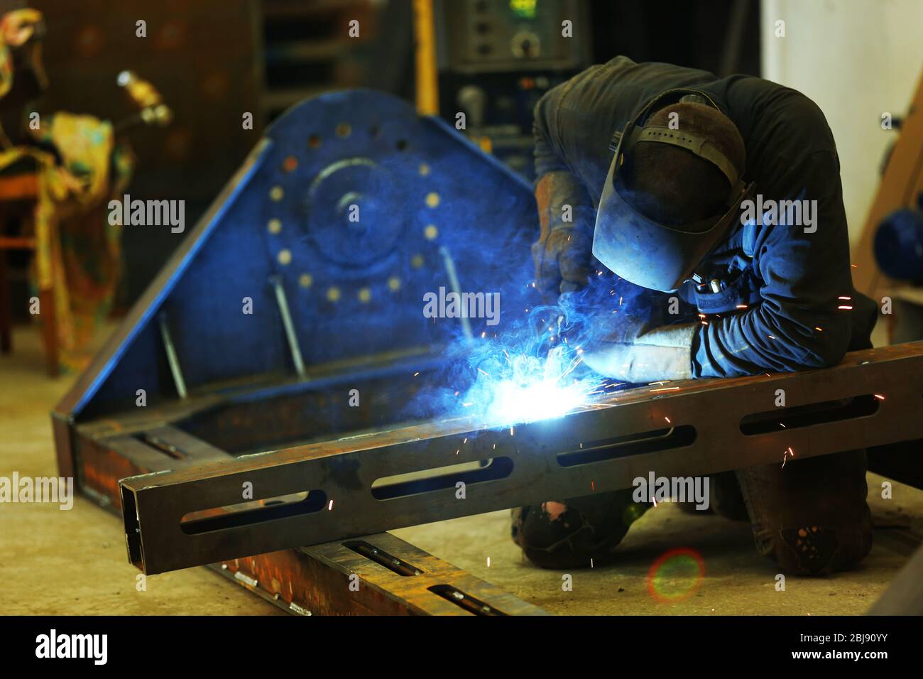 Welder working in garage hi-res stock photography and images - Alamy