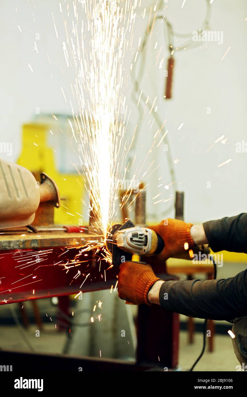 Man working with angle grinder Stock Photo - Alamy