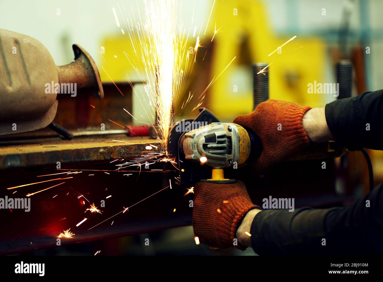 Man working with angle grinder Stock Photo - Alamy