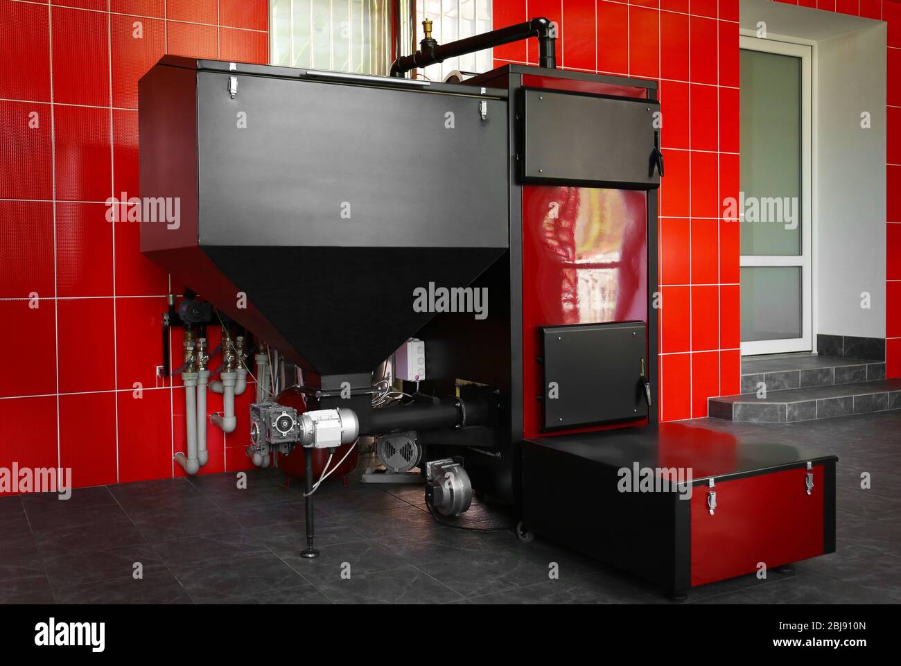Solid-fuel boiler in the boiler room Stock Photo - Alamy