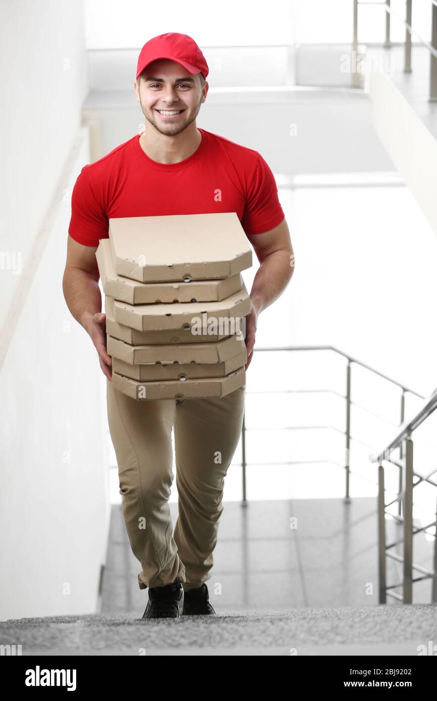 Young handsome man delivering pizza Stock Photo - Alamy