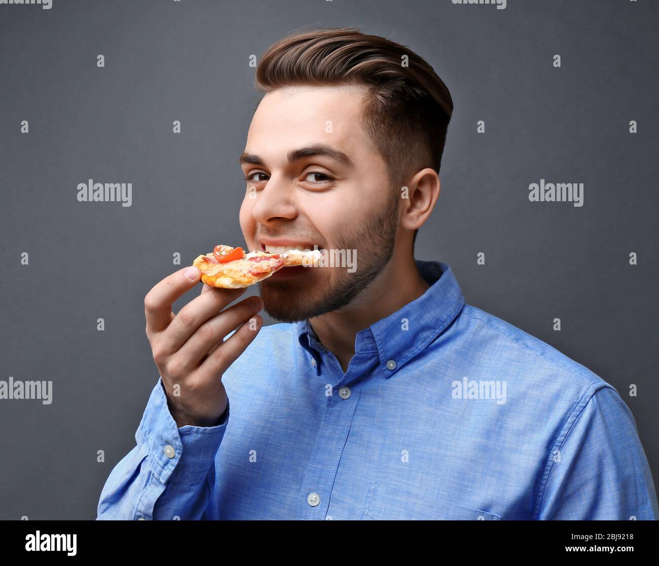 Handsome man eating pizza hi-res stock photography and images - Alamy