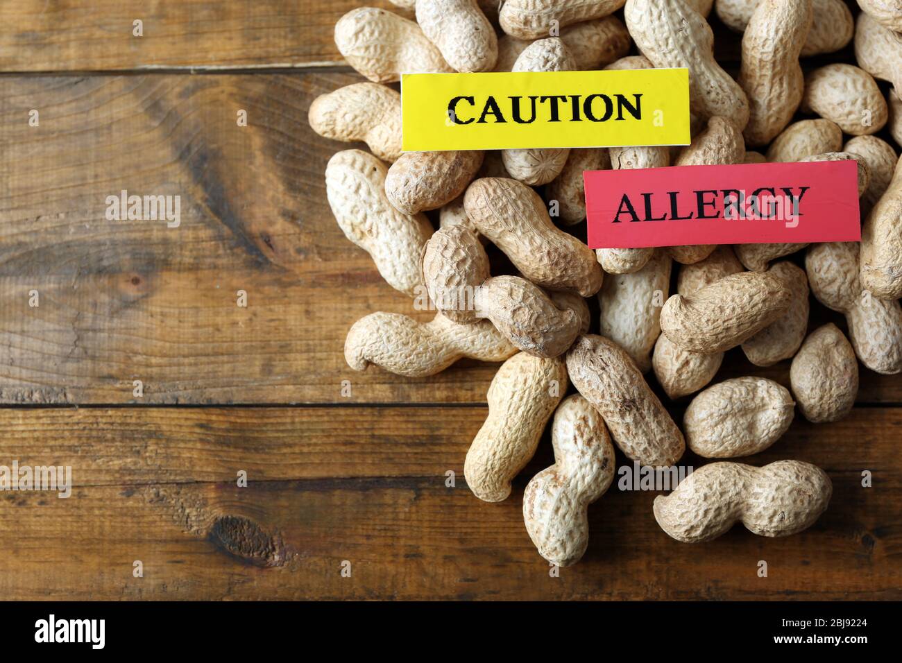 Allergy food concept. Pile of hazelnuts on wooden background Stock ...