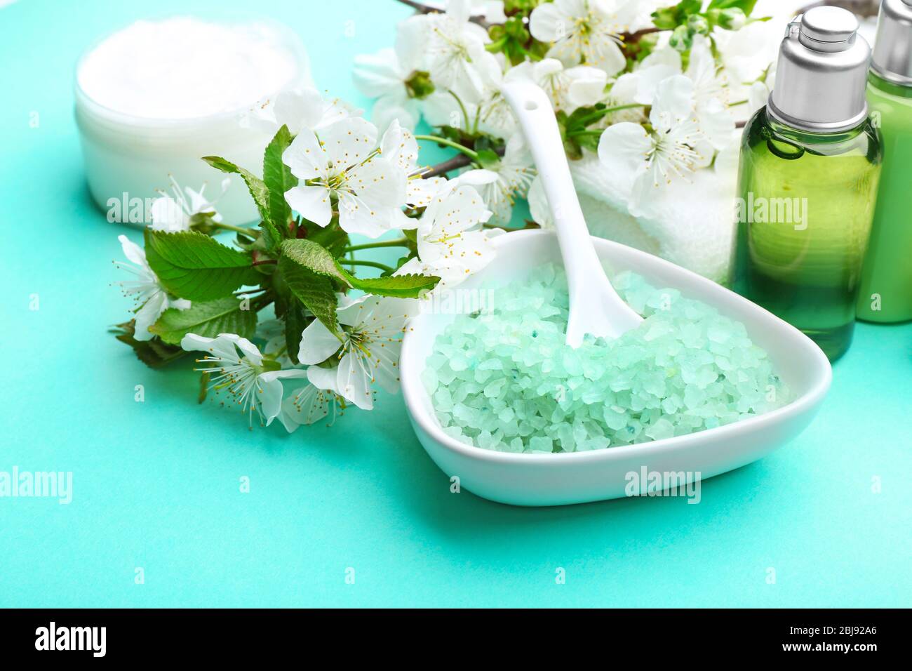 Spa treatment with blooming branch on turquoise background Stock Photo ...