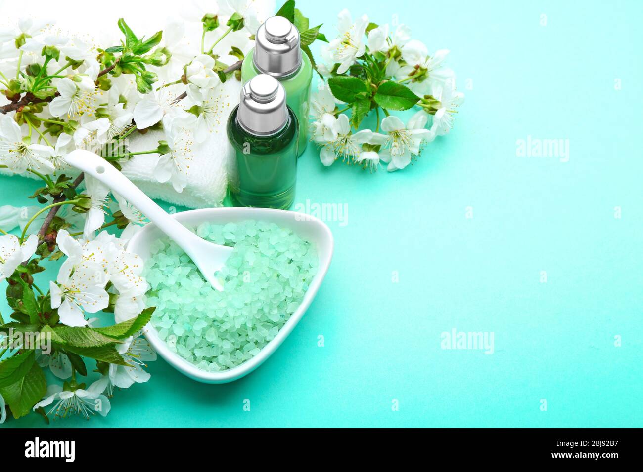 Spa treatment with blooming branch on turquoise background Stock Photo ...