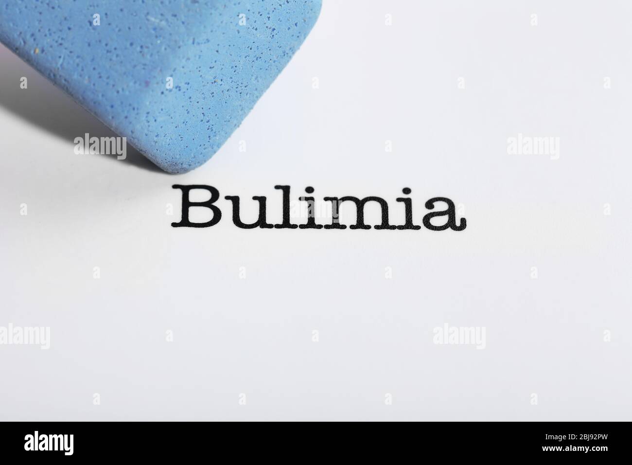 Bulimia word with eraser on white paper background Stock Photo - Alamy