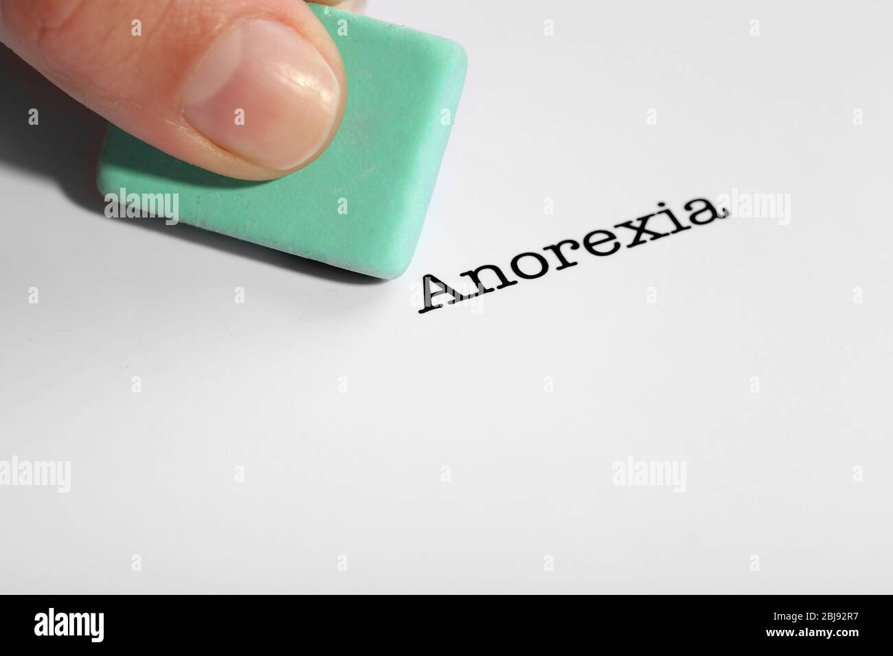 Anorexia word with eraser on white paper background Stock Photo - Alamy
