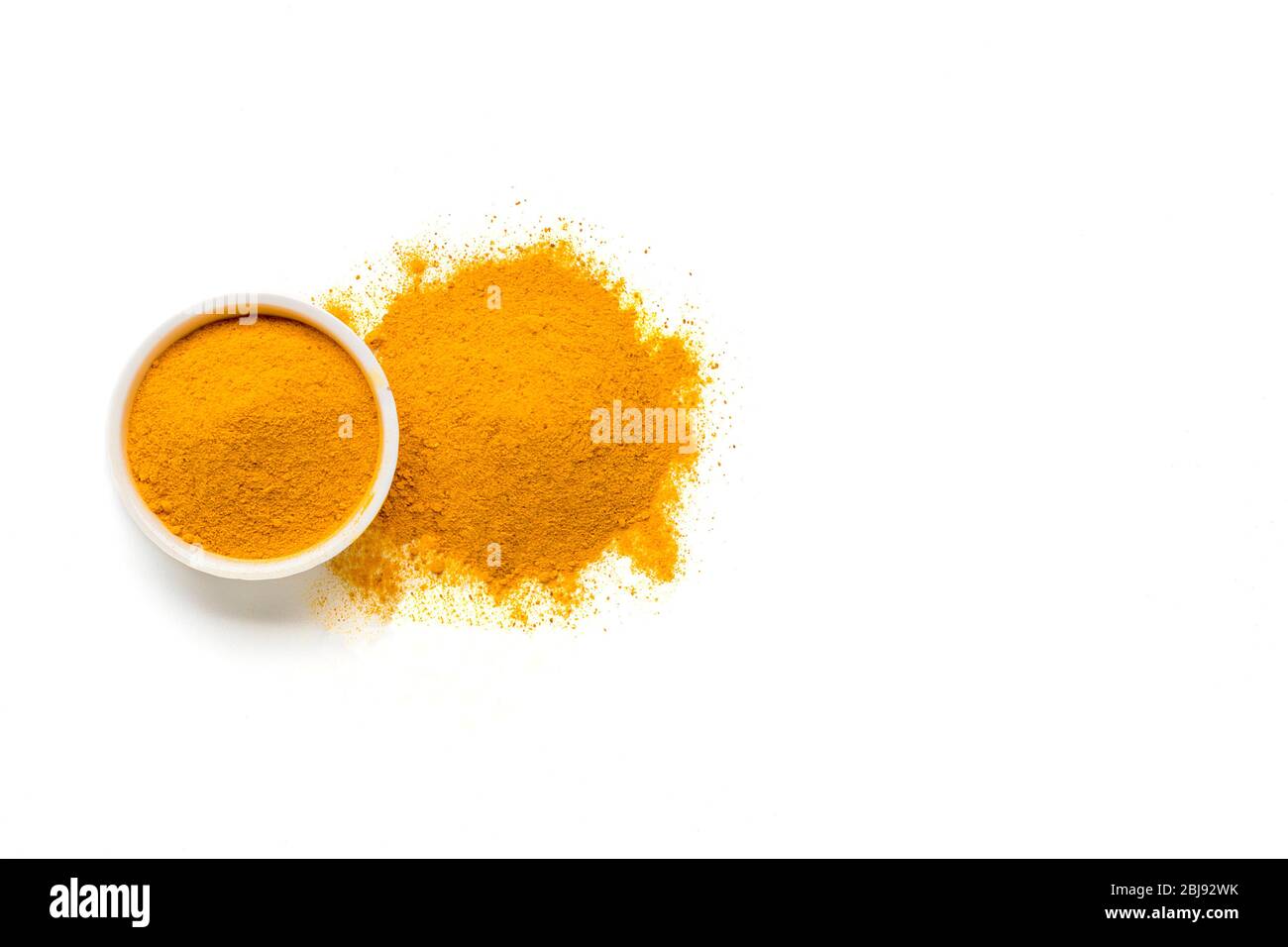 Orange dried turmeric, curcumin , yellow ginger powder in white glass ...